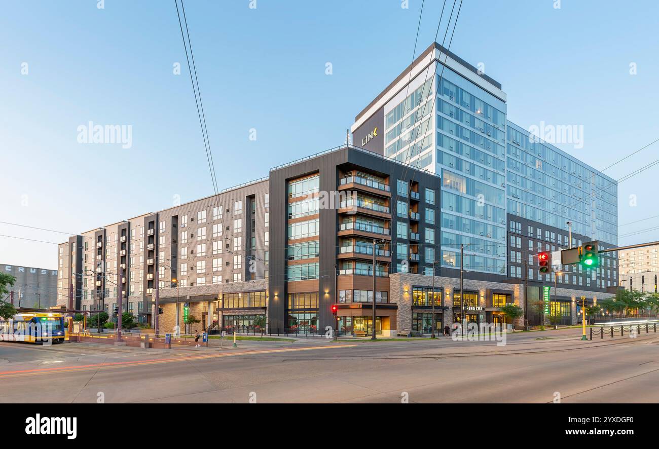 Front corner of large apartment building next to light rail station ...