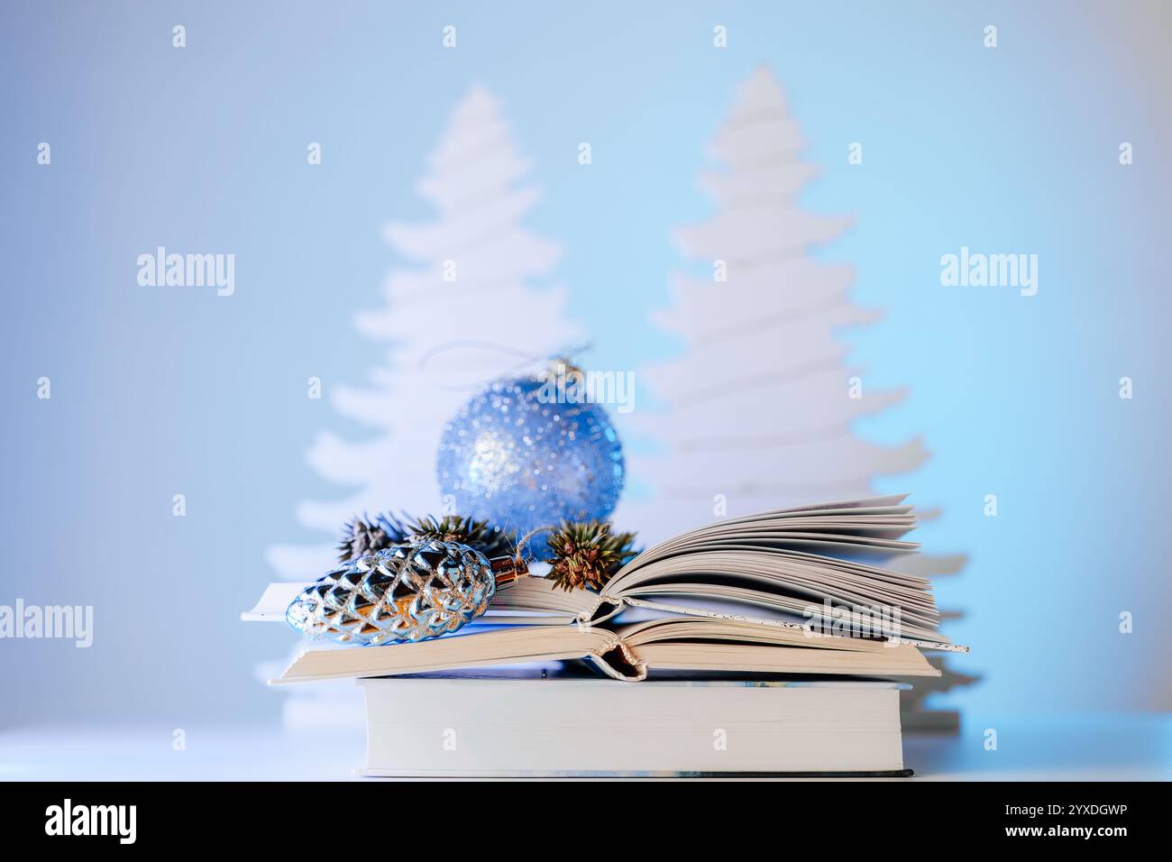 Christmas books.Winter cozy reading.Open books stack, spruce branch ...