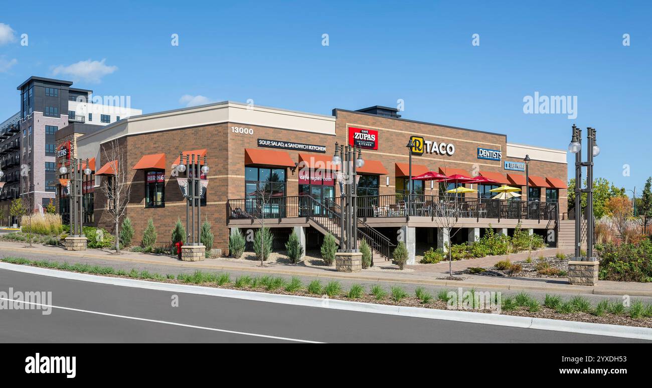 Strip mall seen from angle with various shops and restaurants has back ...