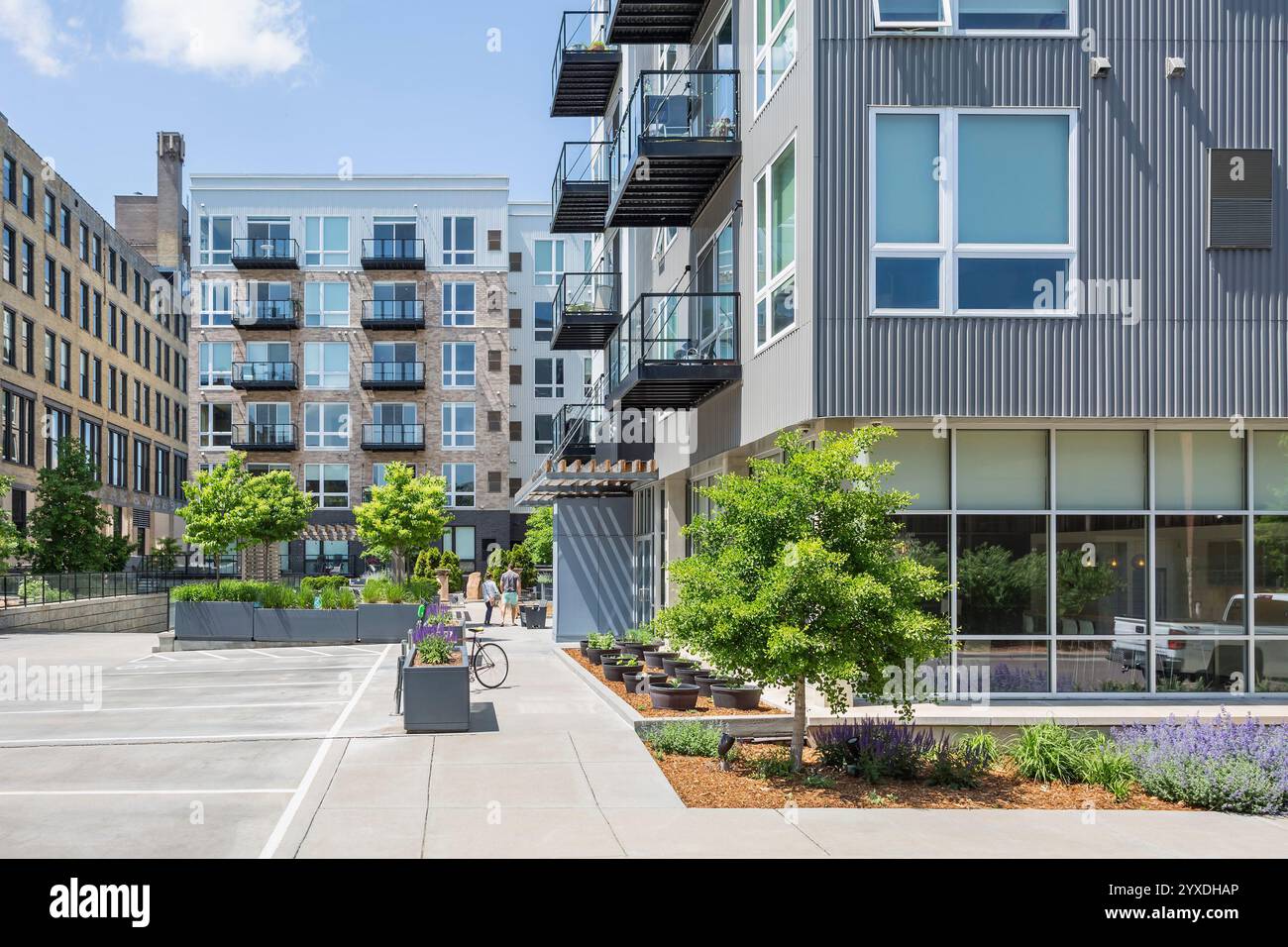 Back exterior of new apartment building showing courtyard patio with ...