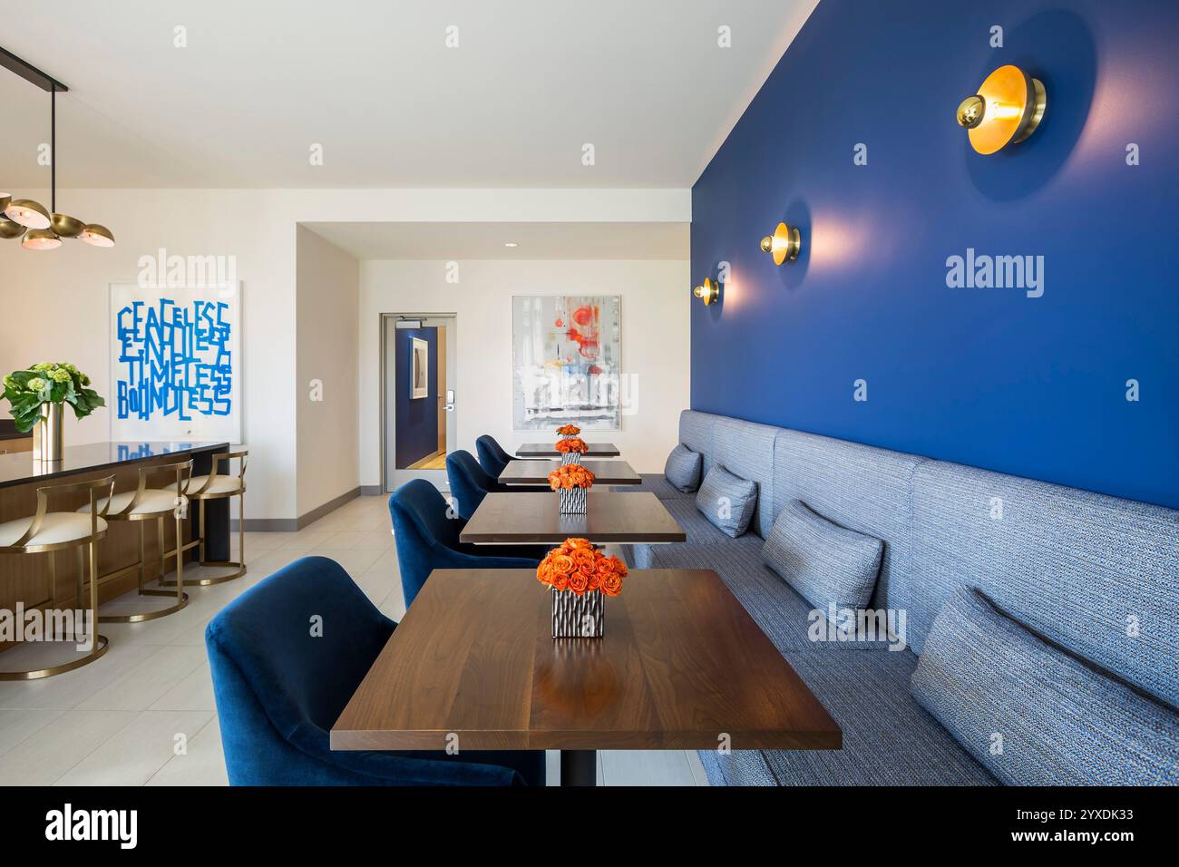 Upscale lounge in new apartment building showing kitchen area with ...