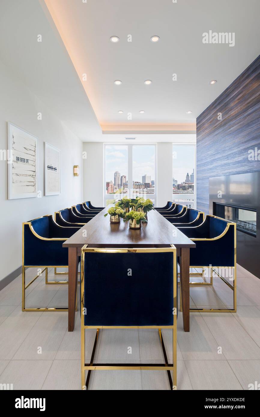 Upper floor lounge in new apartment building showing long table next to ...