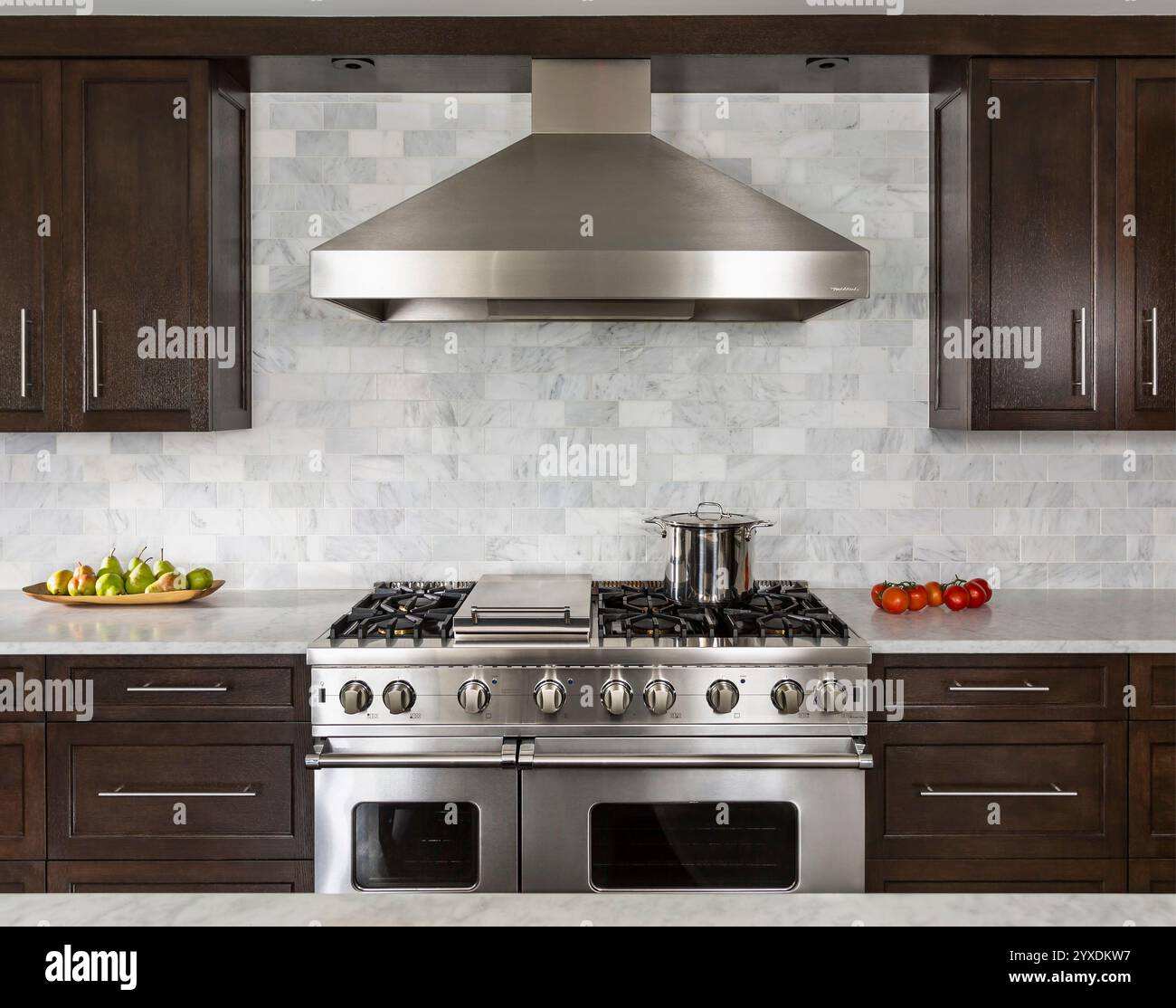 HIgh end stainless steel stove surrounded by dark wood cabinets and ...