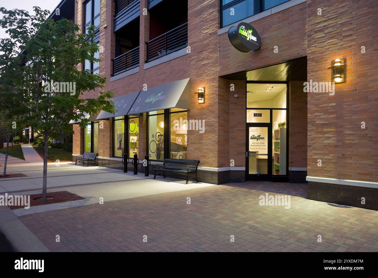 Very nice commercial building exterior showing retail space at dusk ...