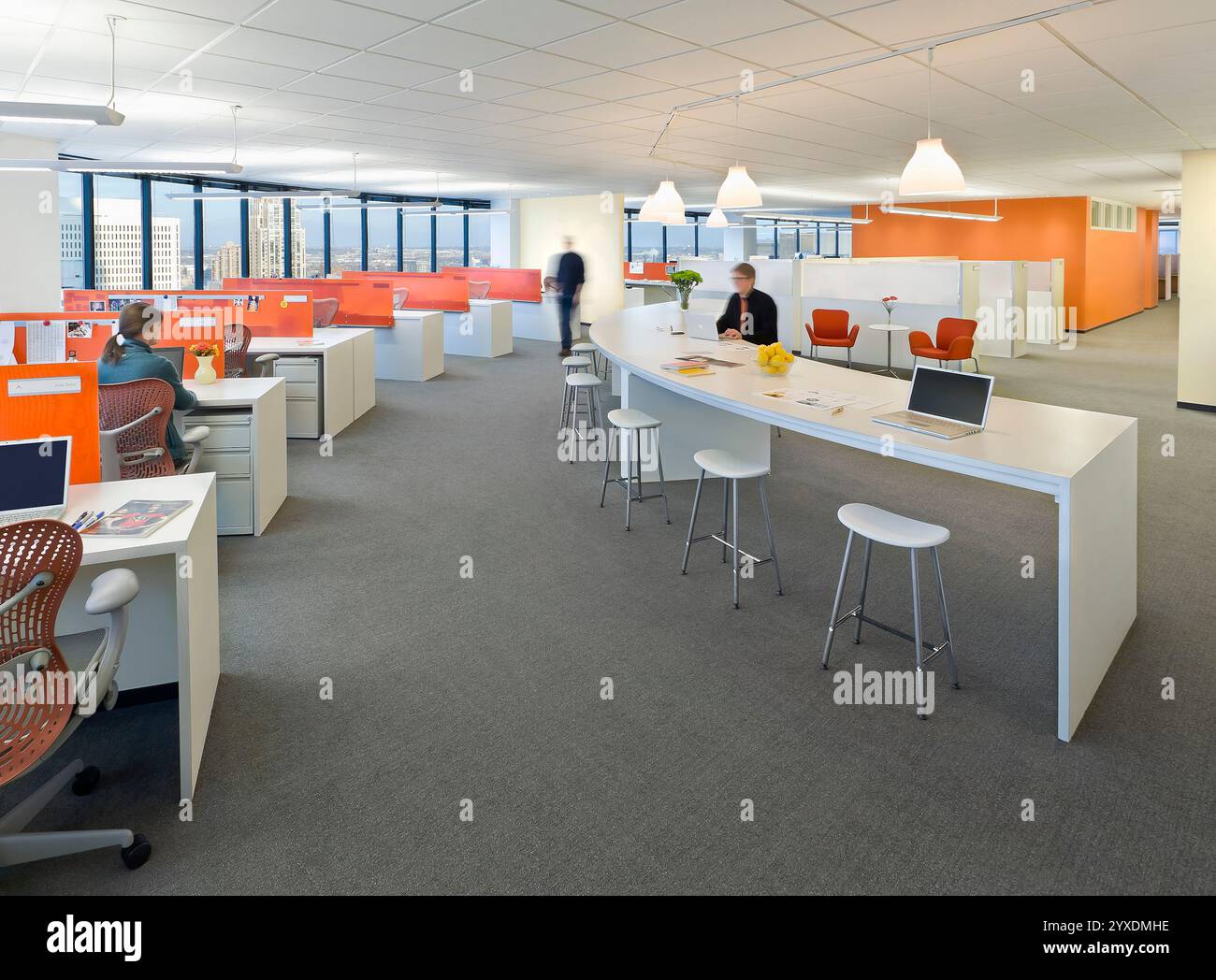 Circular open office space with white and orange furniture and large ...