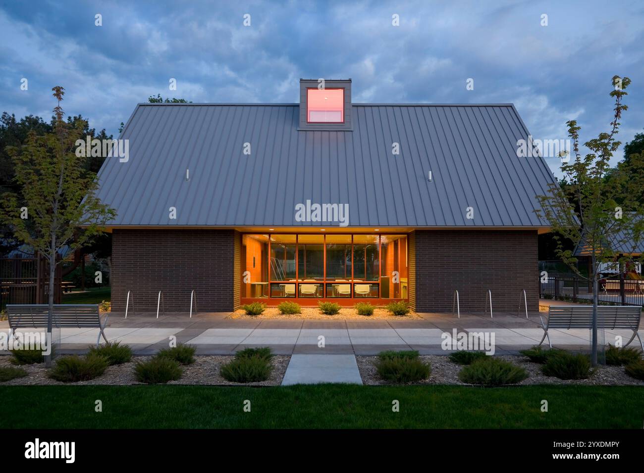 Elevation view of modern park structure lit up at dusk Stock Photo - Alamy