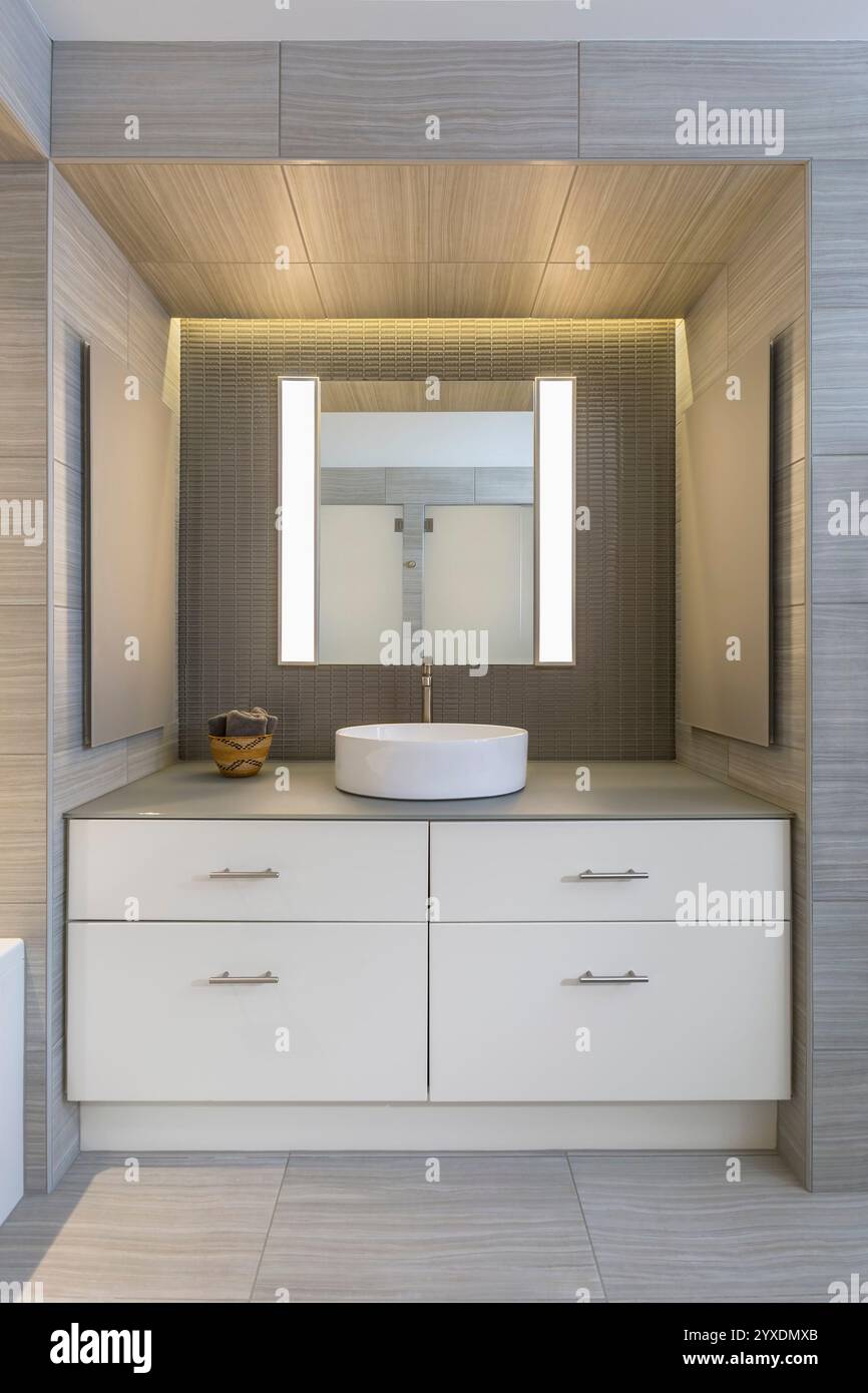 Custom white vanity cabinet is tucked between two walls hi-res stock ...
