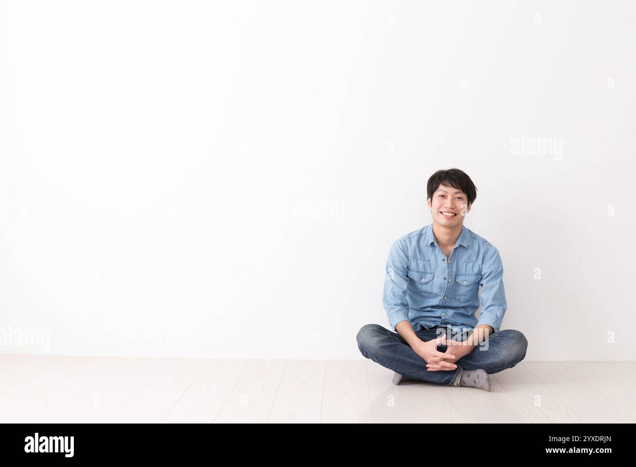 Cross legged young man hi-res stock photography and images - Alamy