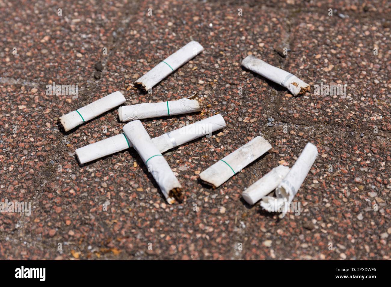 Discarded cigarette butts Stock Photo - Alamy