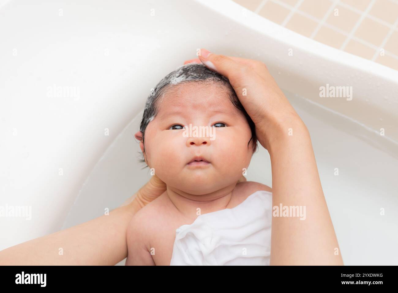 Newborn baby being bathed Stock Photo - Alamy