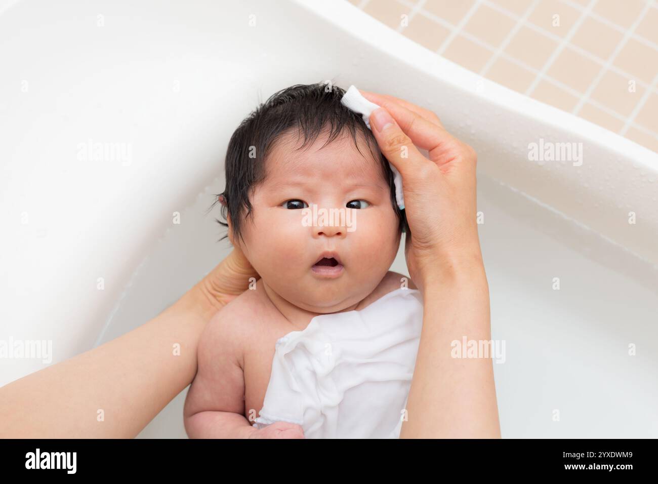 Newborn baby being bathed Stock Photo - Alamy