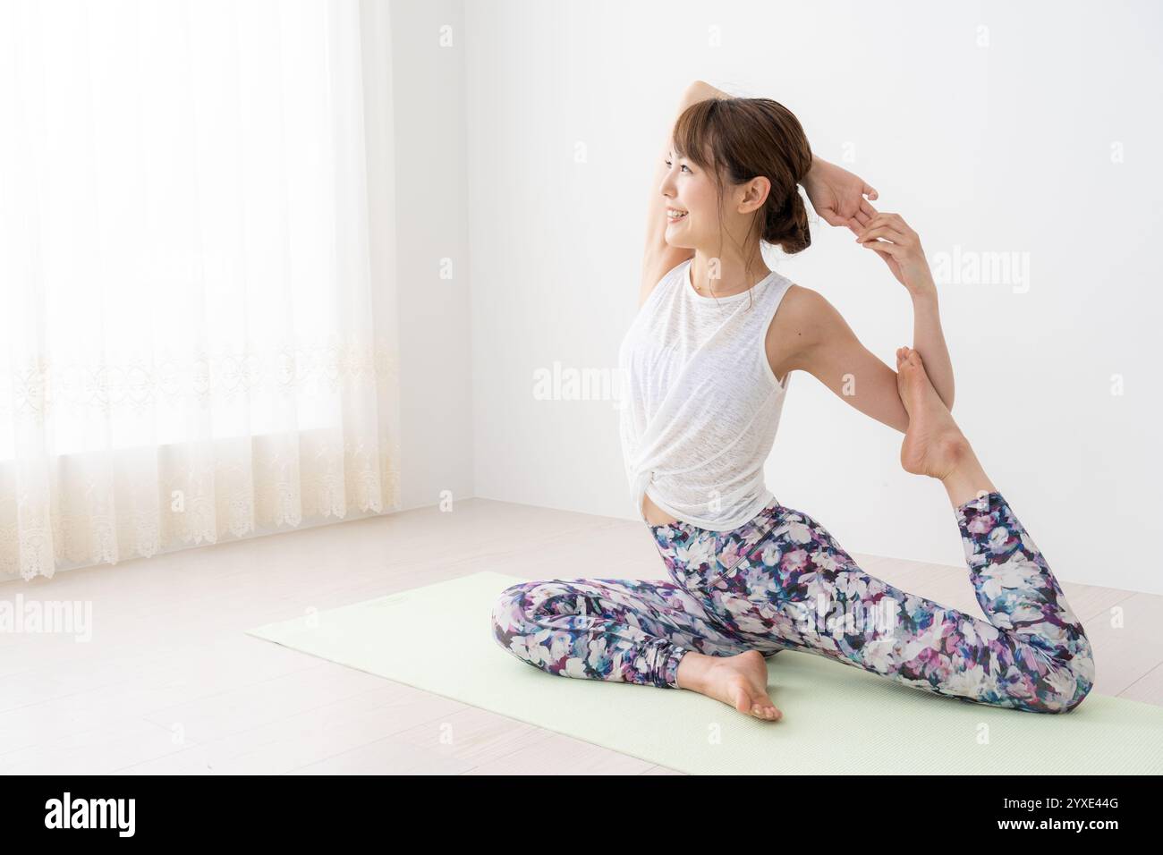 Japanese woman doing yoga Stock Photo - Alamy