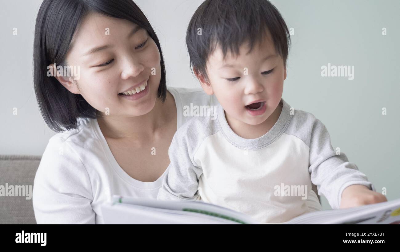 Child reading a book Stock Photo - Alamy