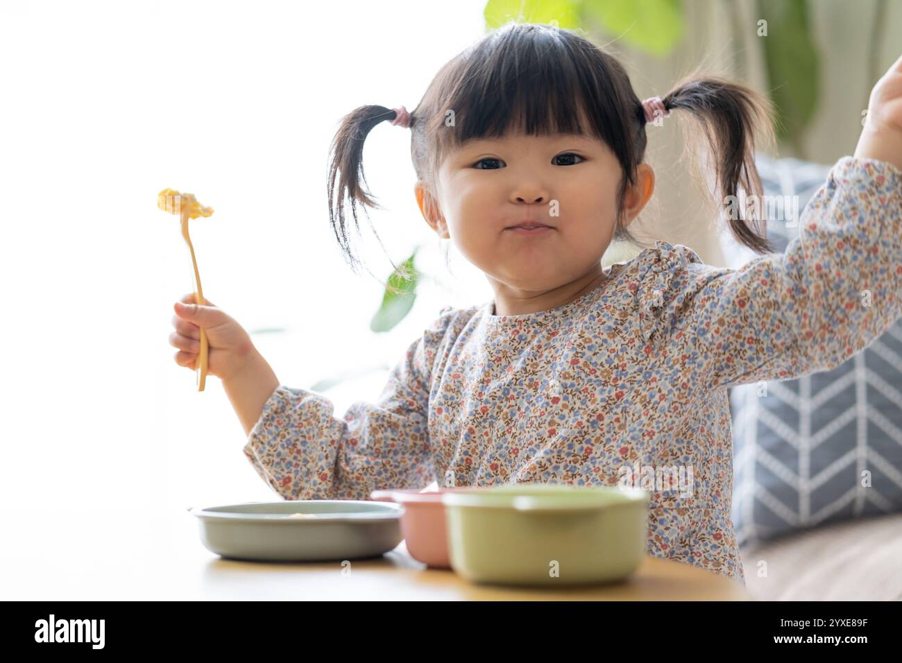 Girl eating a meal Stock Photo - Alamy
