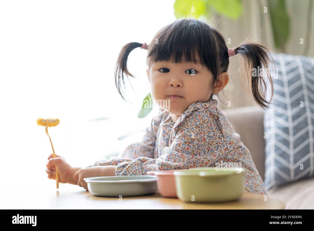 Girl eating a meal Stock Photo - Alamy