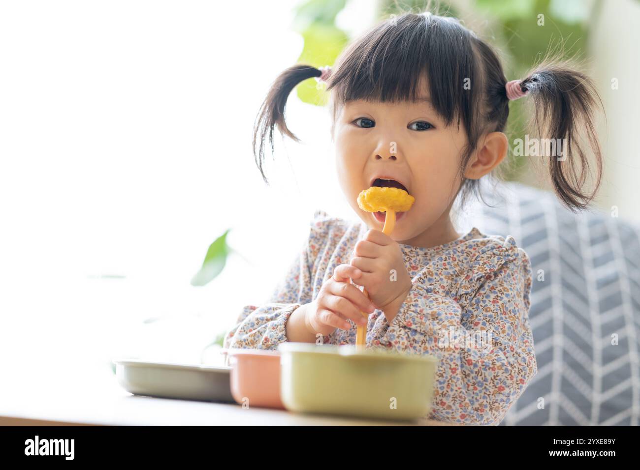 Girl eating a meal Stock Photo - Alamy