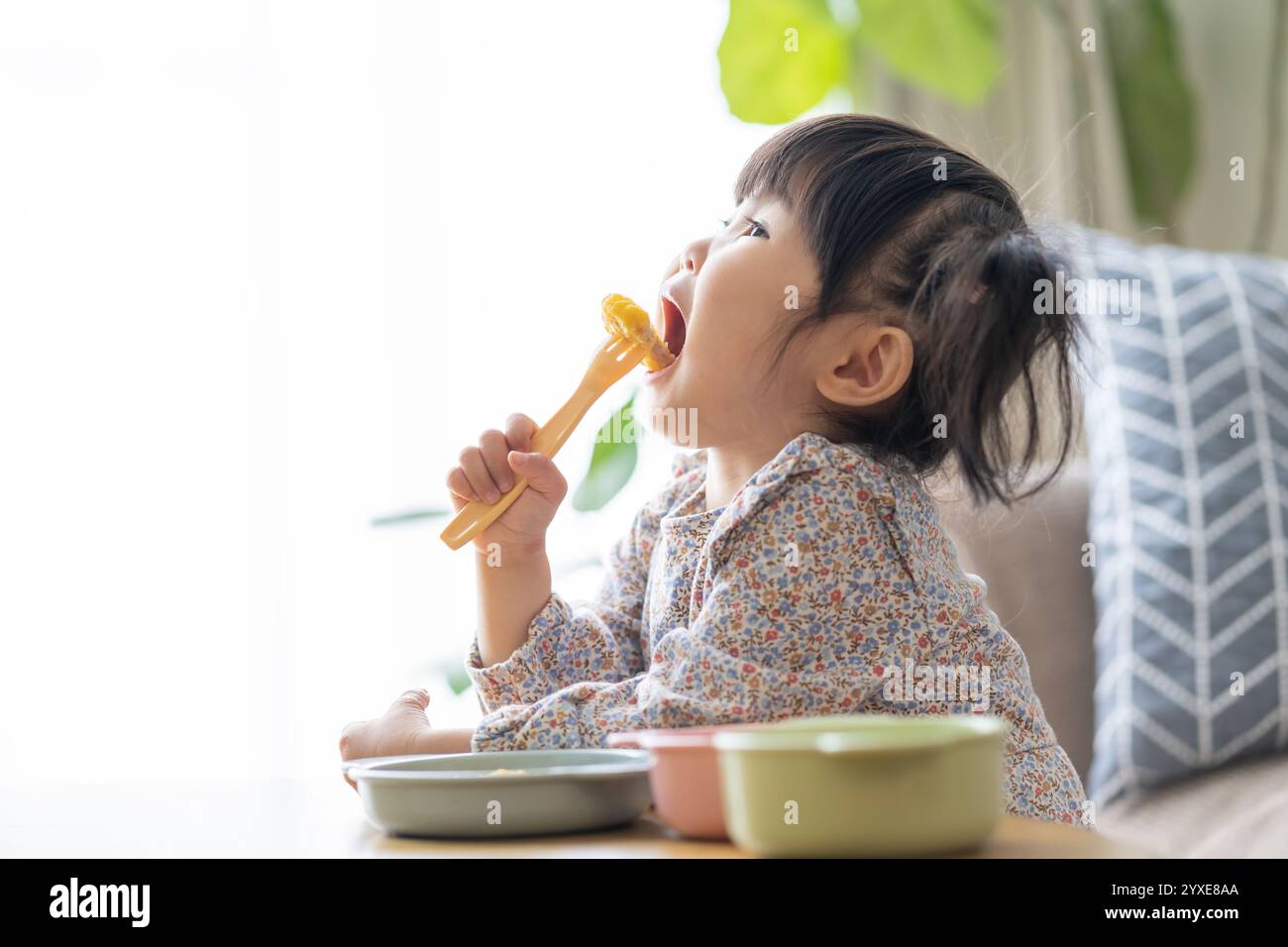 Girl eating a meal Stock Photo - Alamy