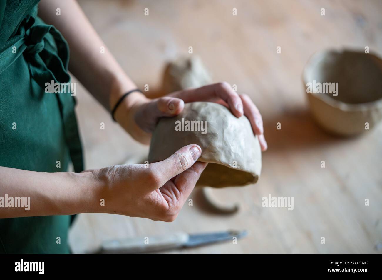 Work with your hands - artist woman molding raw clay for sculpturing ...