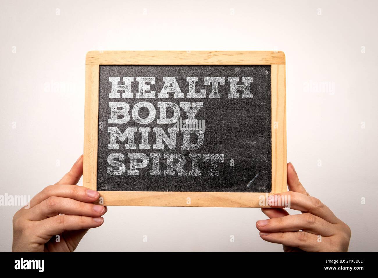 Health Body Mind Spirit. Chalkboard with text in hands on white ...