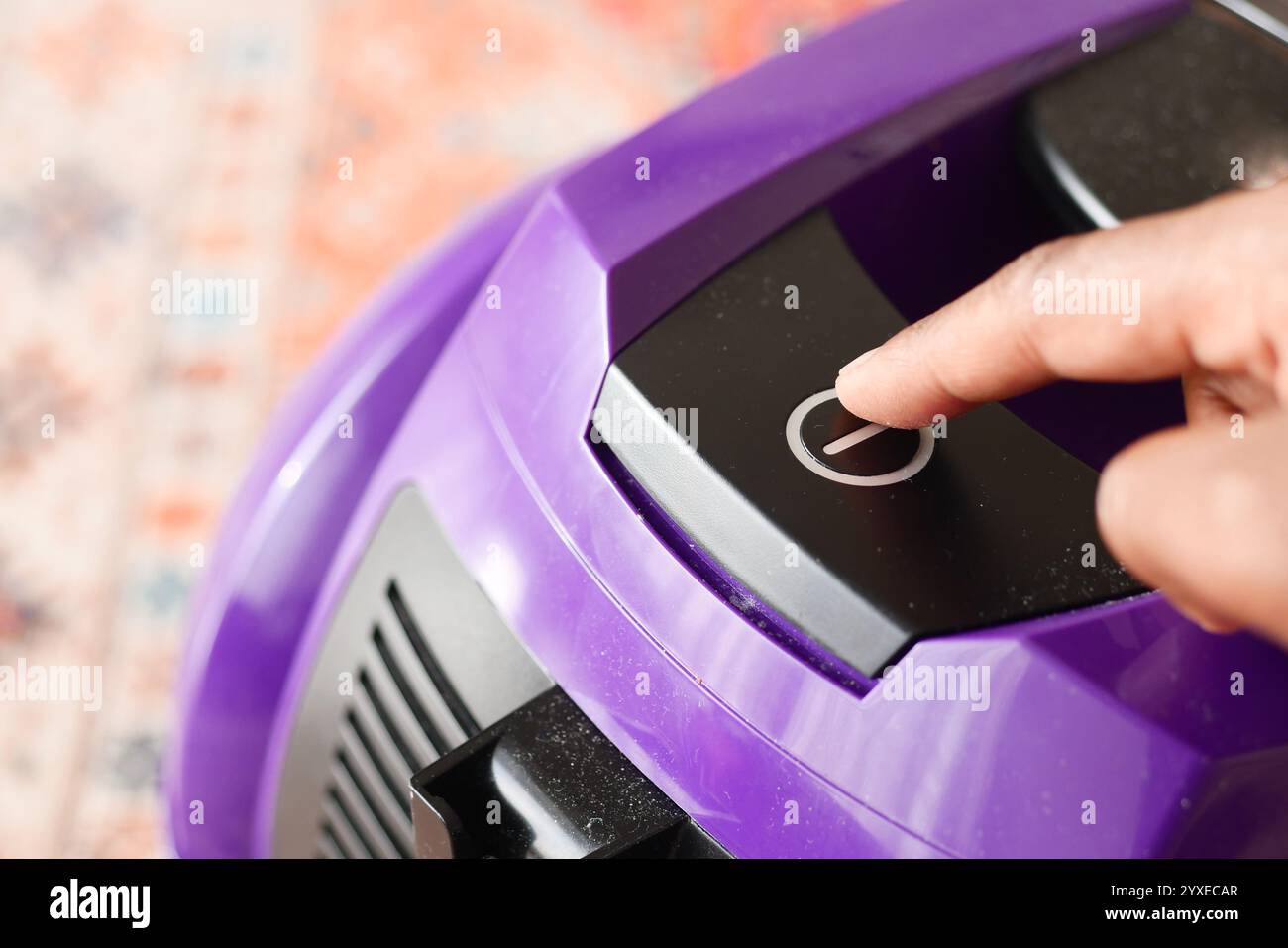 pressing start button on vacuum cleaner Stock Photo - Alamy
