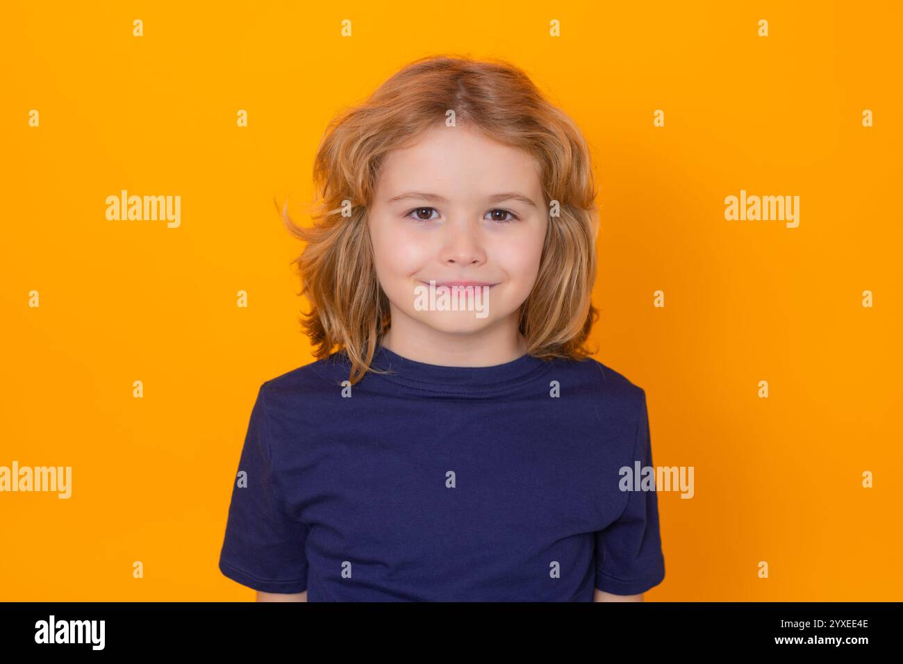 Portrait of cute smiling childon yellow studio background. Happy kid ...