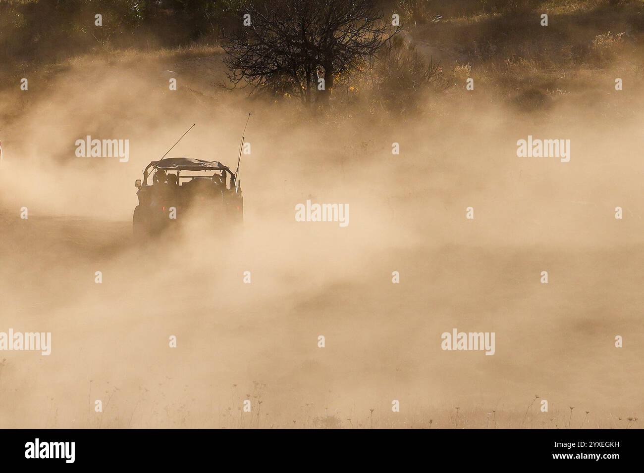 An Israeli armoured vehicle crosses the security fence moving towards ...