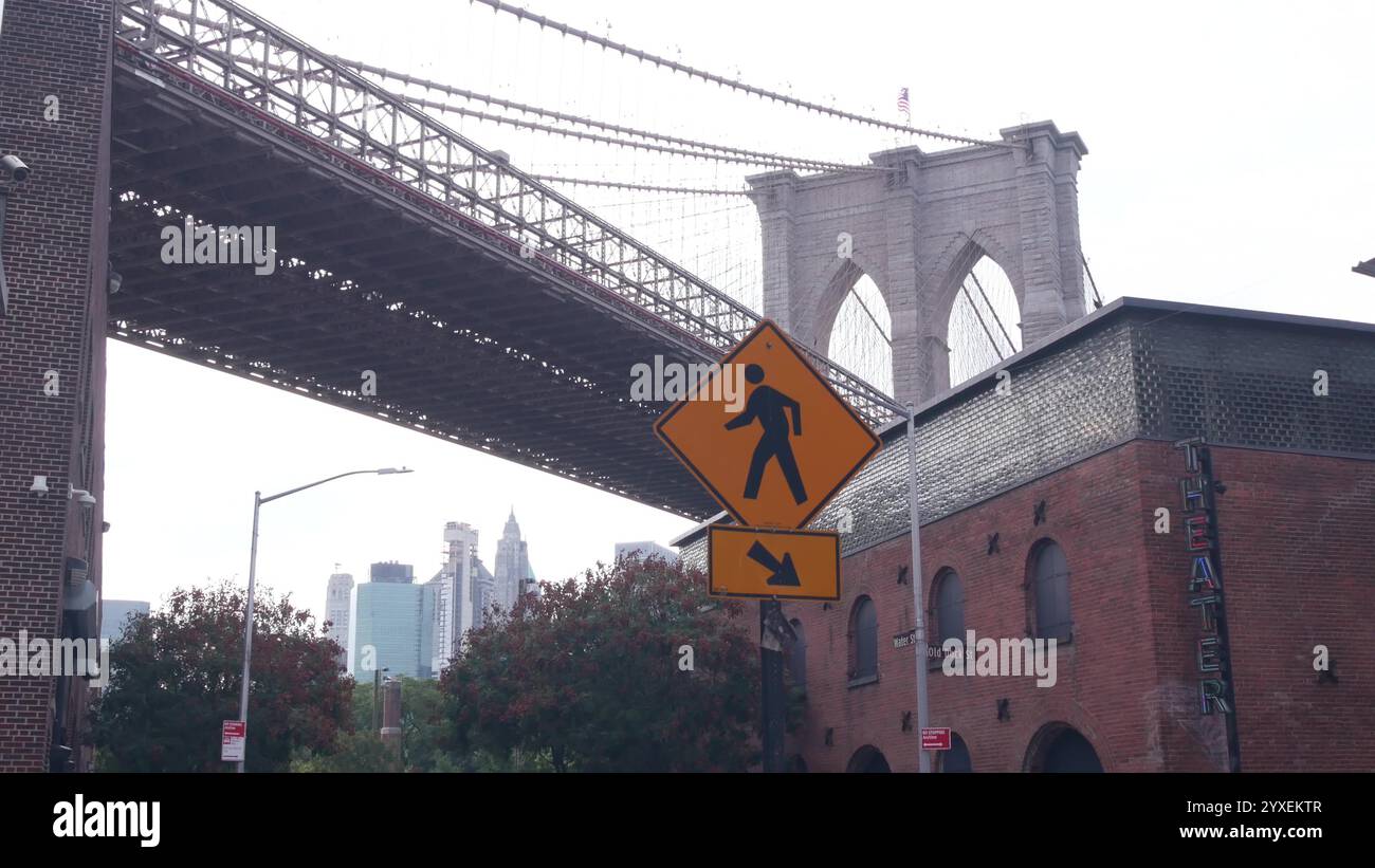 New York City Brooklyn Bridge from Dumbo. Red brick wall old historic ...