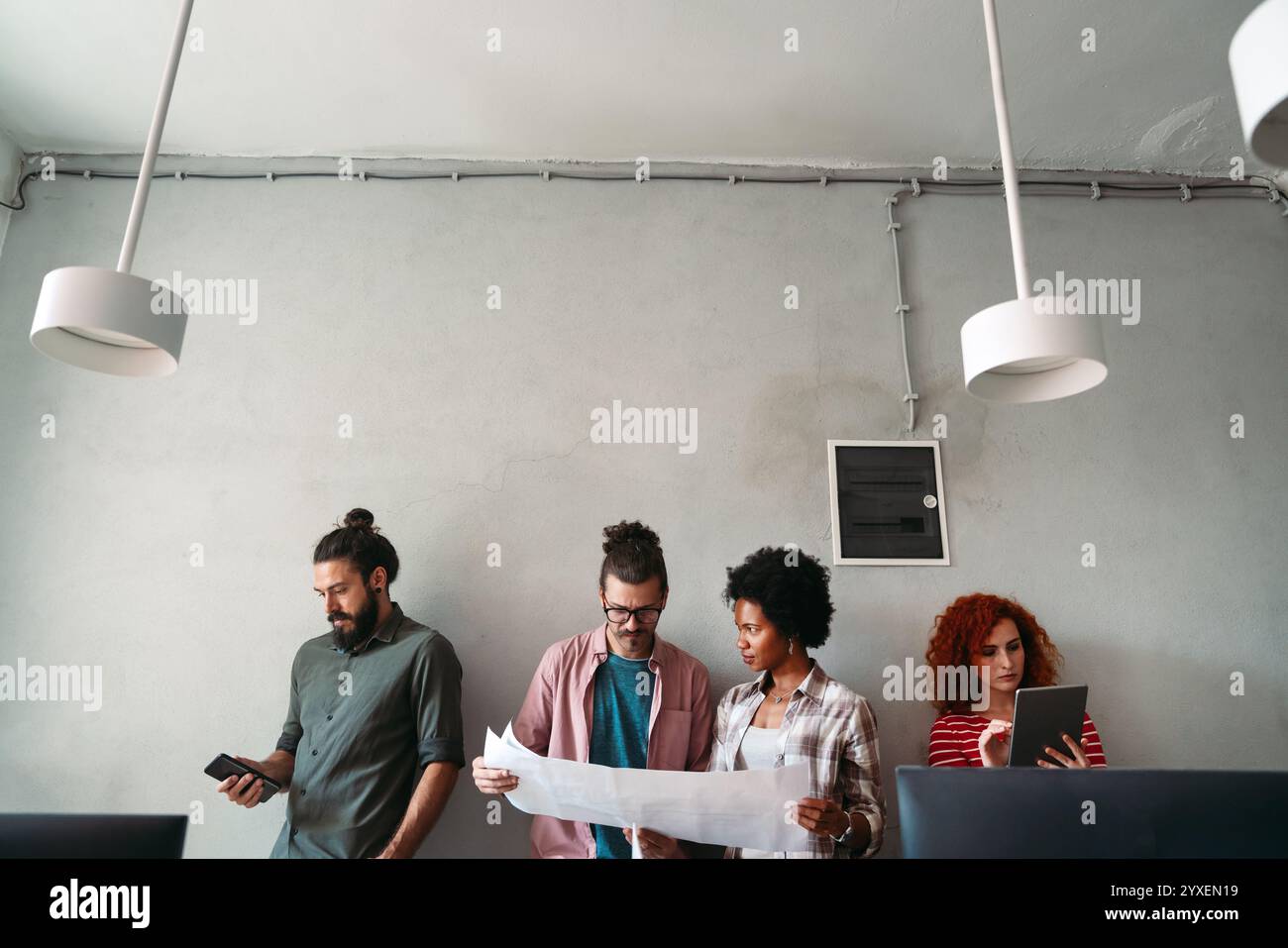 Happy businesspeople laughing while collaborating on a new project in an office. Business ...