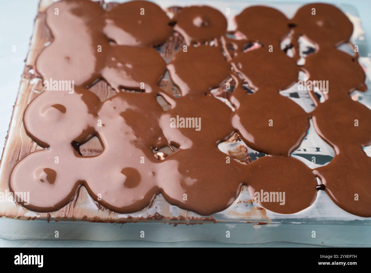 The mold for making chocolate candies is filled with solidified ...
