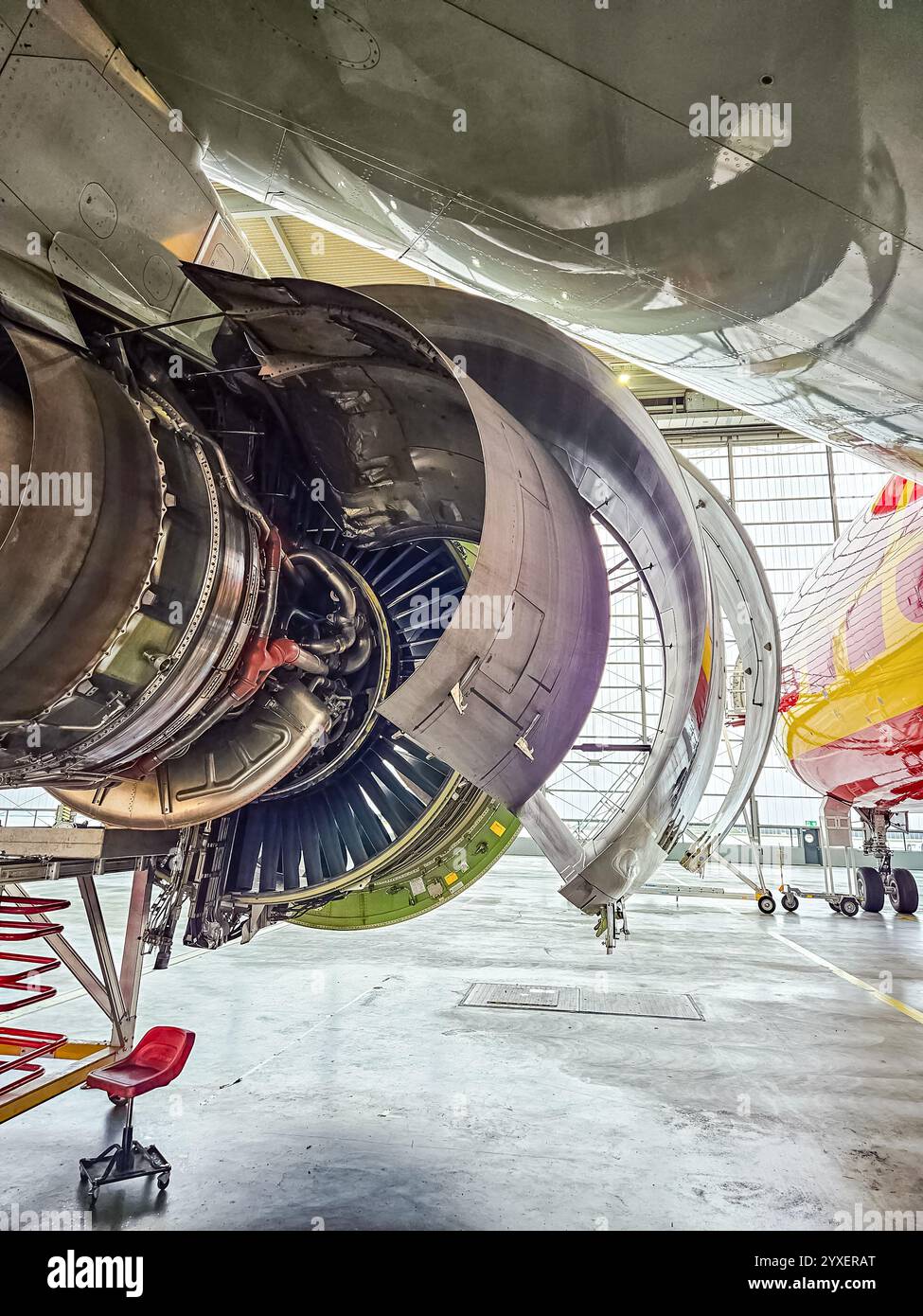 Aircraft engine servicing in hangar, with various tools and equipment ...