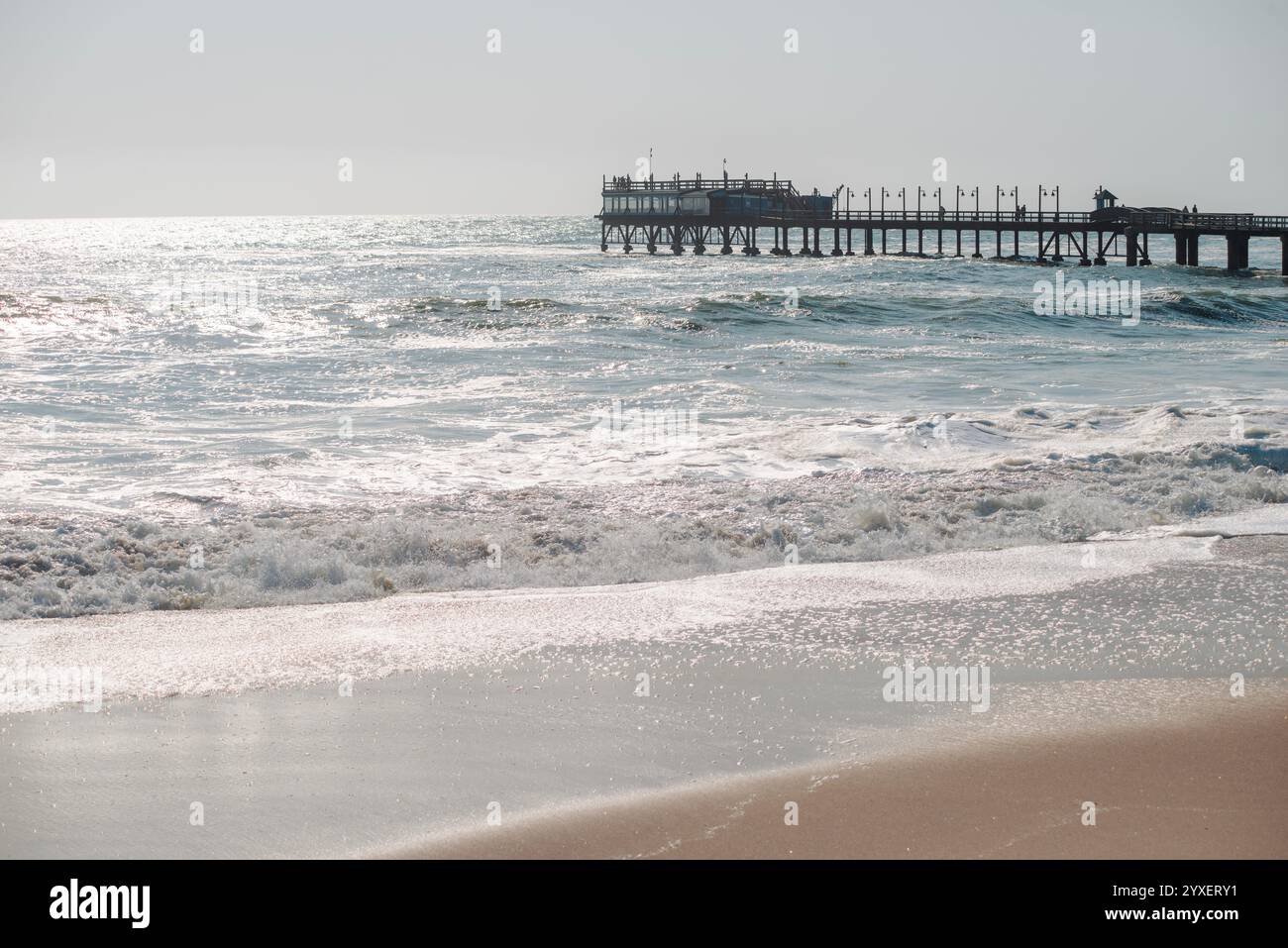 empty sand beach with distant ocean pier in Swakopmund, Namibia Stock ...
