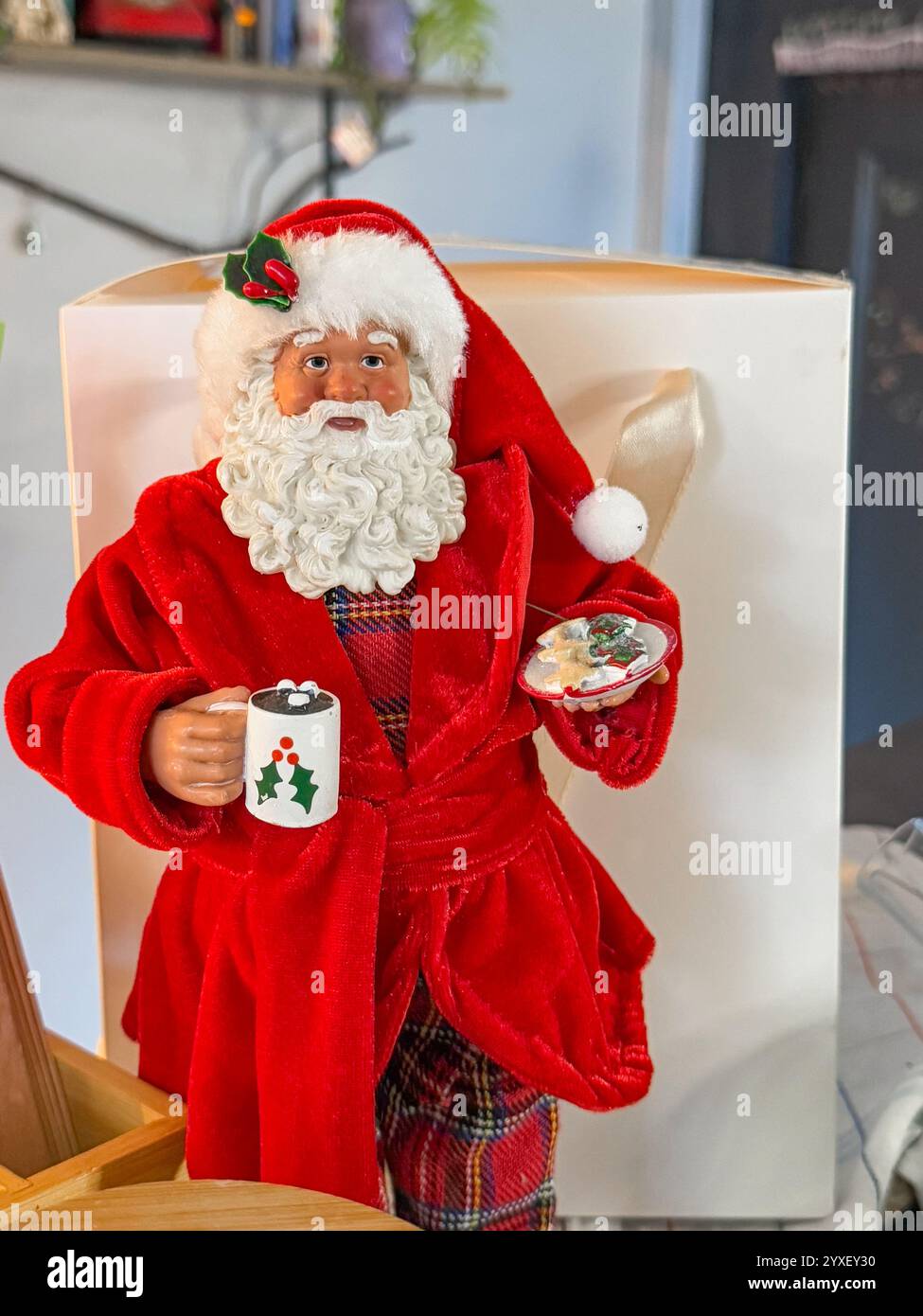 This charming photo features a Santa Claus figurine dressed in a cozy ...