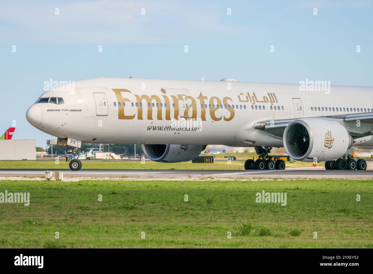 Emirates boeing 777 300er airplane taxiing on the runway at lisbon ...