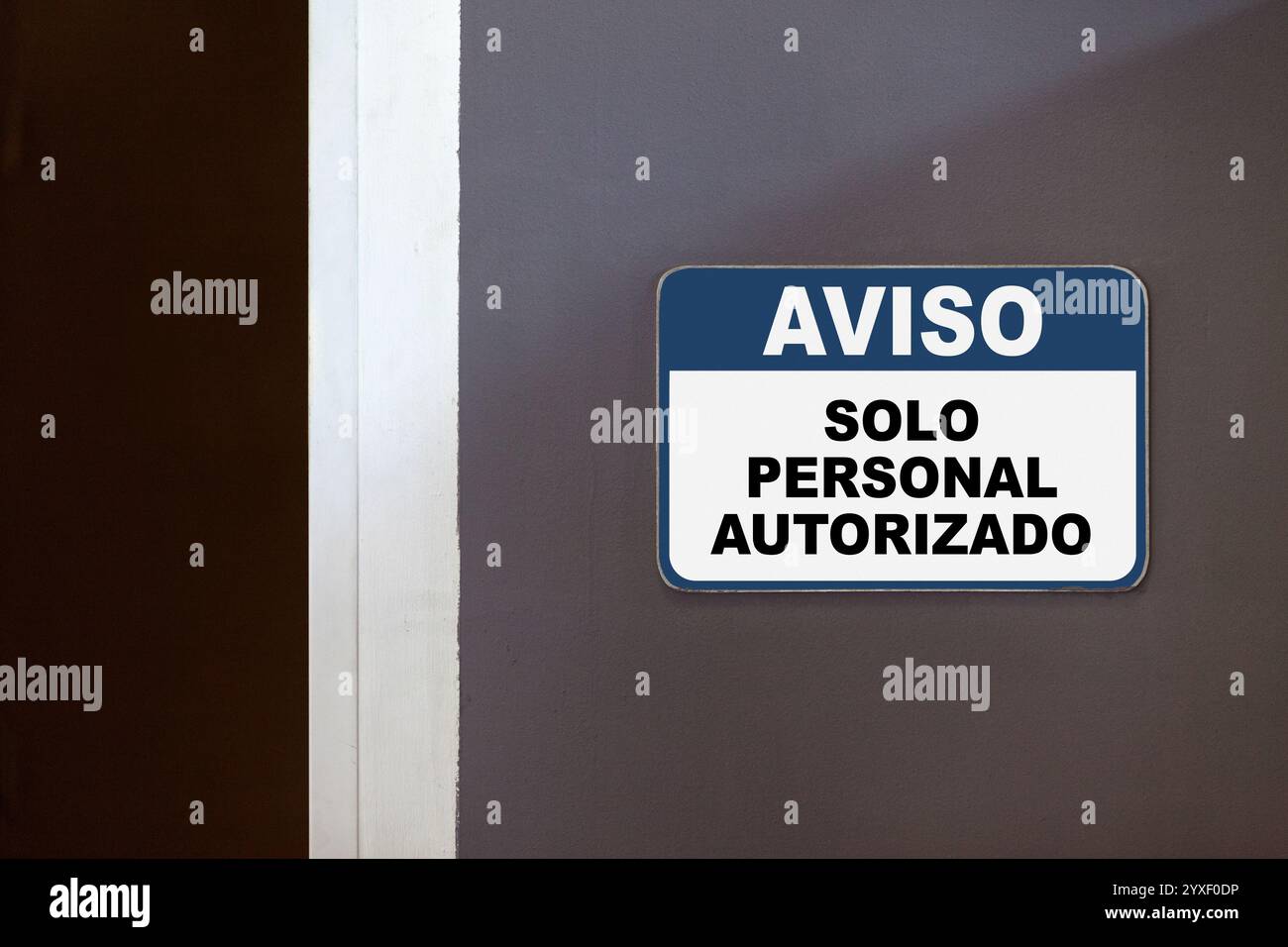 Blue and white notice sign on the side of an open door stating in ...