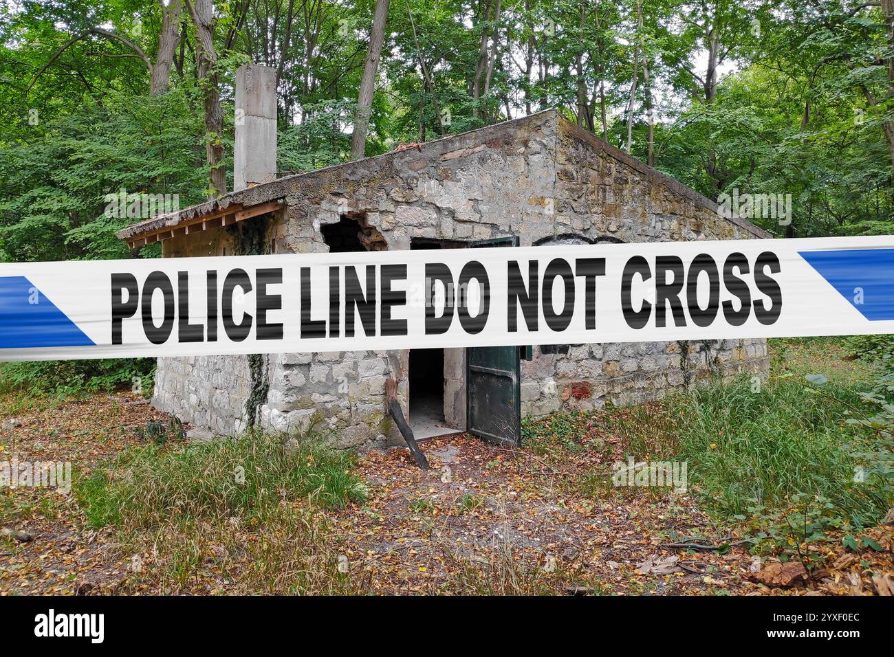 Abandoned stone house in the woods with a police tape with written in ...