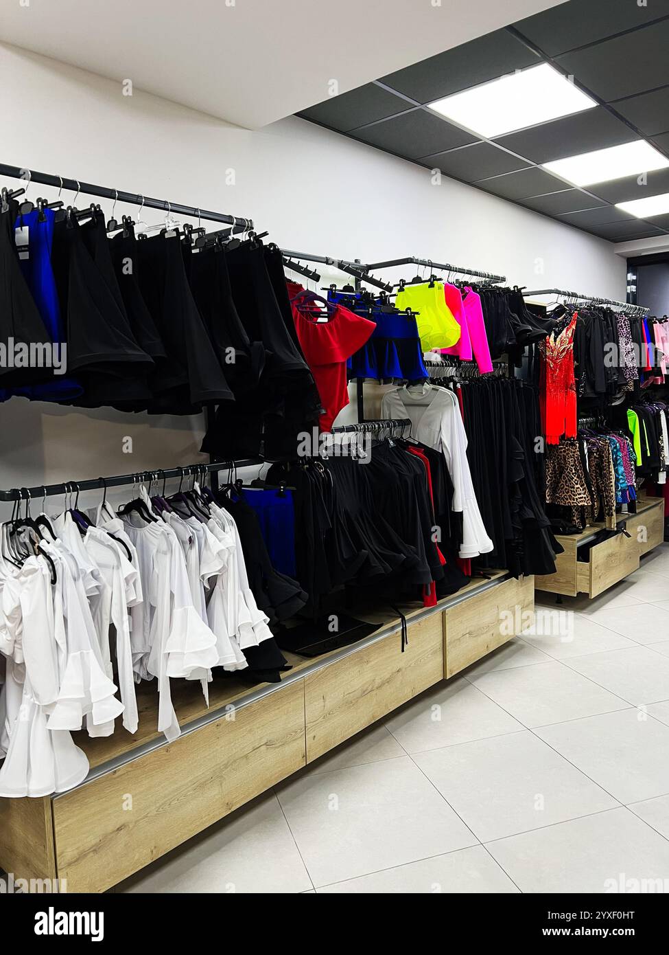 A vibrant display of various dance dresses in a retail shop showcasing ...