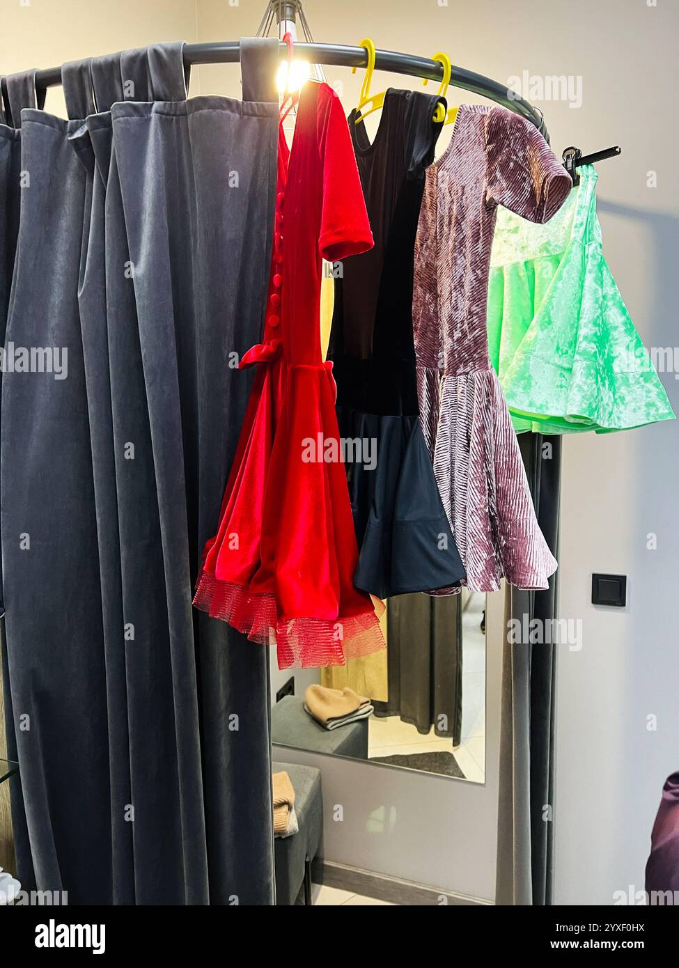 Various vibrant dance dresses showcased in a contemporary fitting room ...
