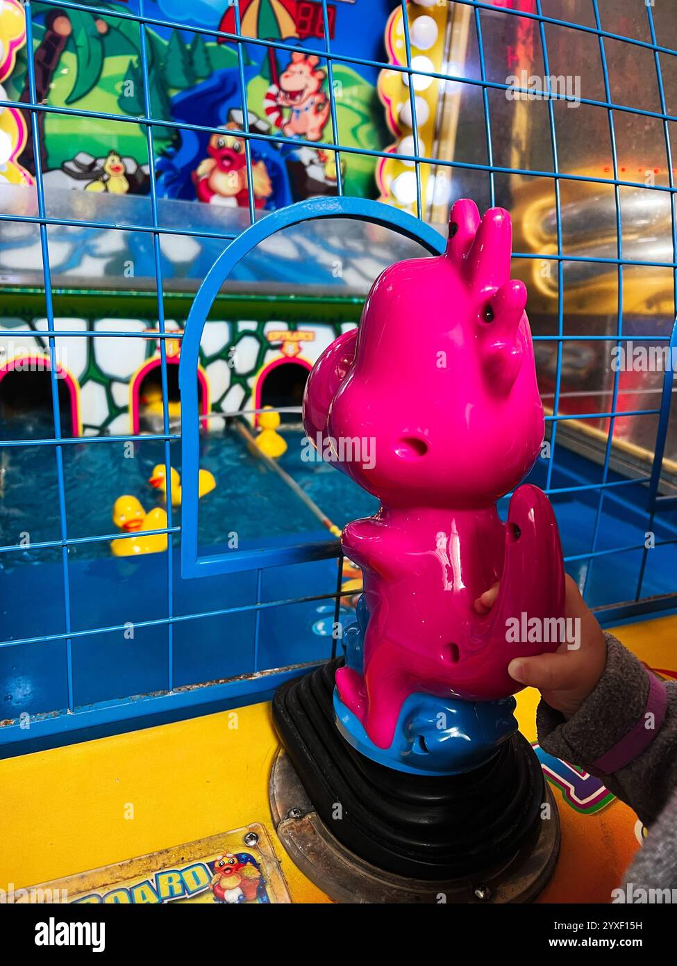 Interactive carnival game setup with a pink toy for controlling motions ...