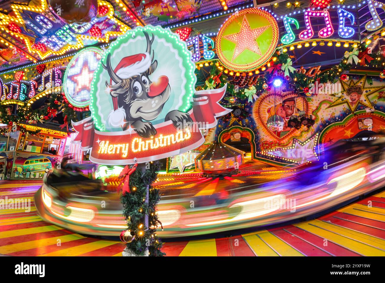 London, UK. 11th Dec, 2024. A vibrant fairground ride illuminates the ...