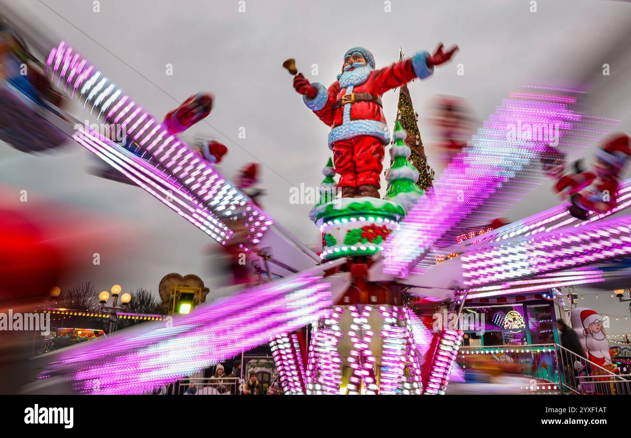 London, UK. 15th Dec, 2024. A vibrant fairground ride illuminates the ...