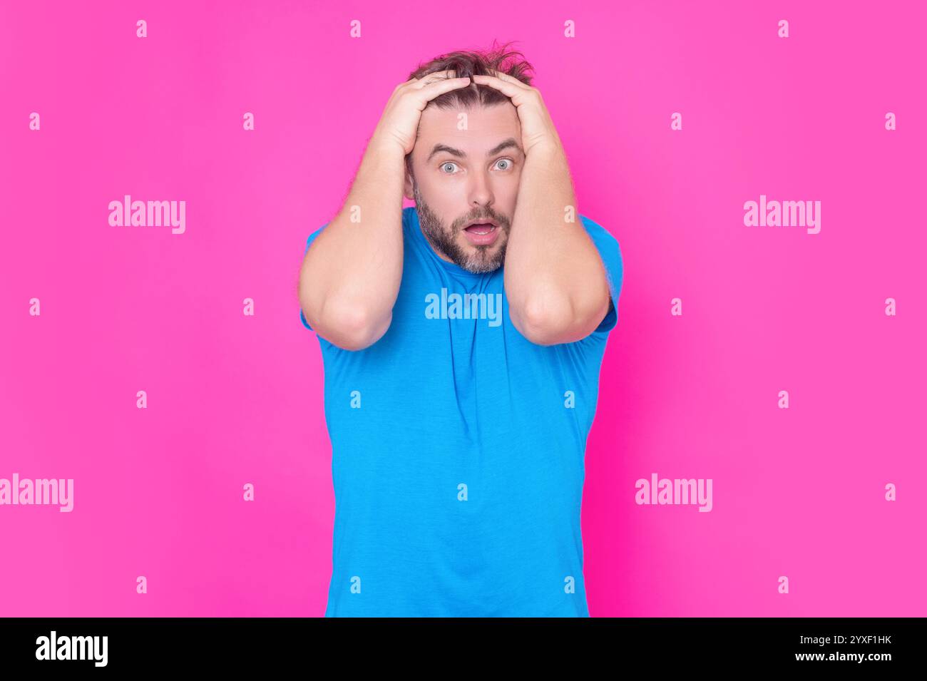 Handsome surprised man over isolated studio background afraid and ...