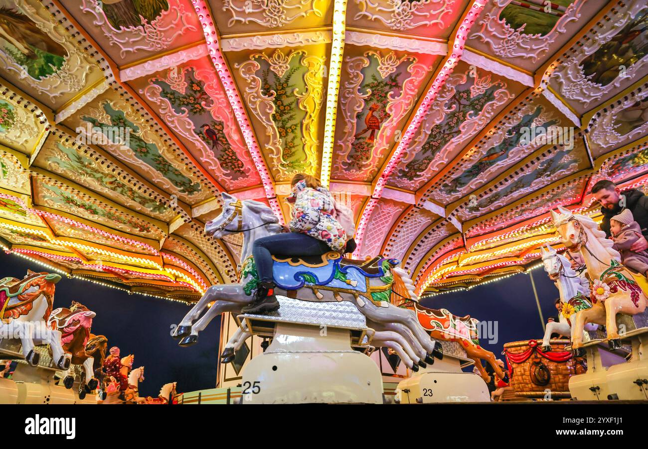 London, UK. 11th Dec, 2024. The 'Old Vienna Horse Carousel' ride proves ...