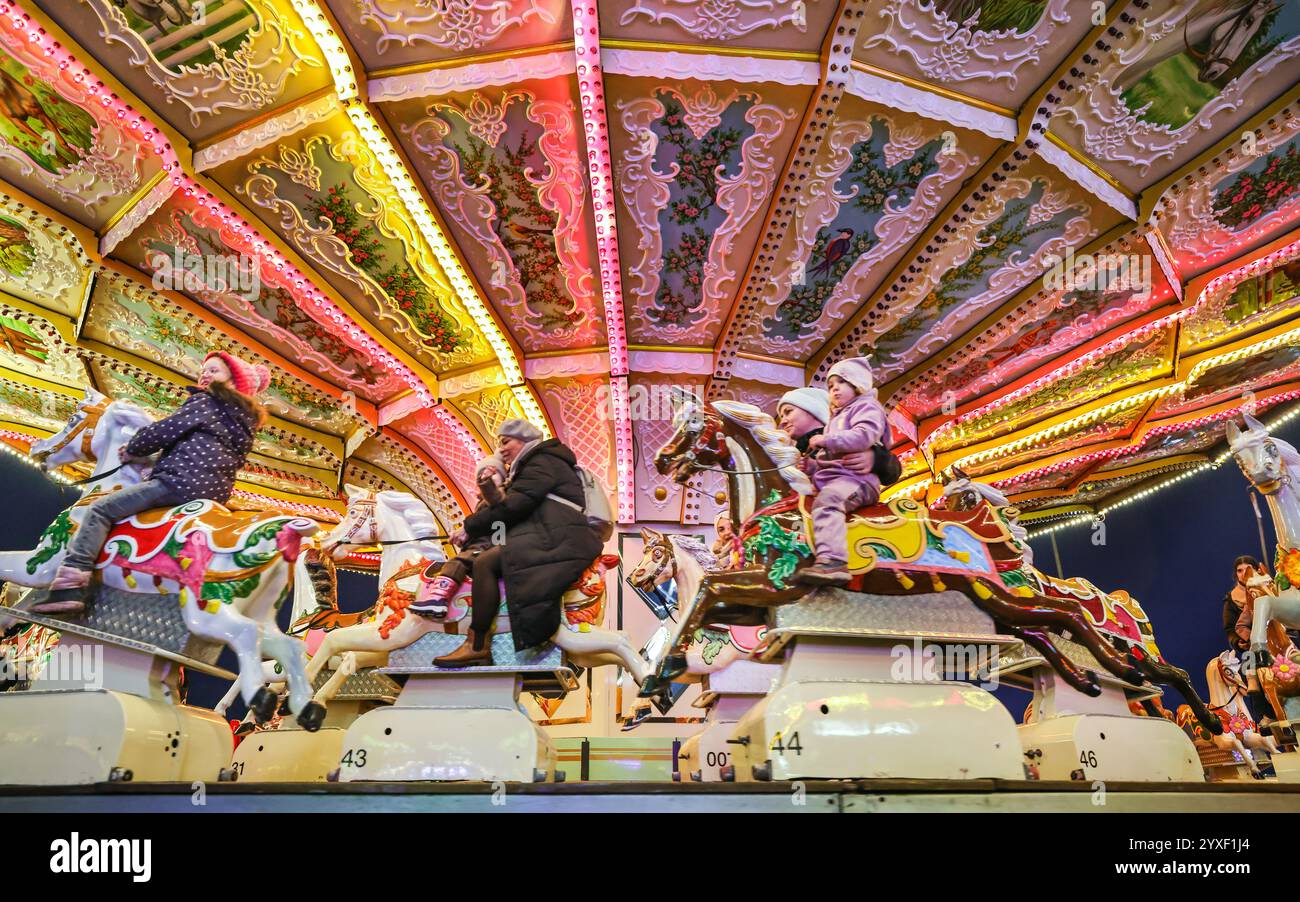 London, UK. 15th Dec, 2024. The 'Old Vienna Horse Carousel' ride proves ...