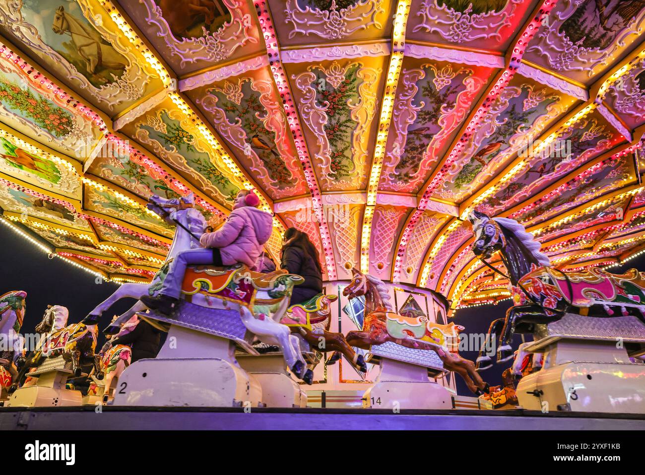 London, UK. 15th Dec, 2024. The 'Old Vienna Horse Carousel' ride proves ...