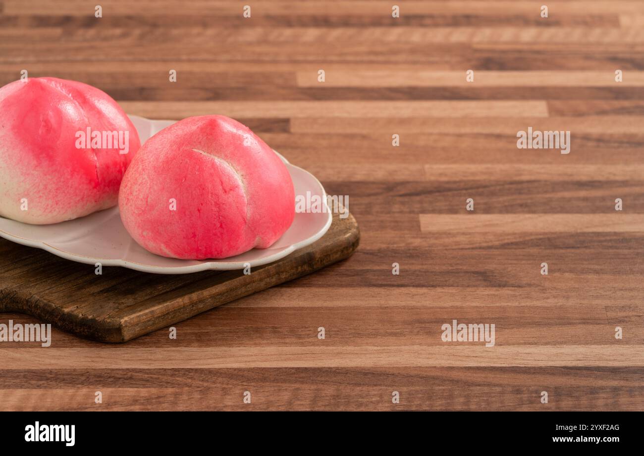 Pink Chinese peach birthday bun food longevity peach shoutao on wooden ...