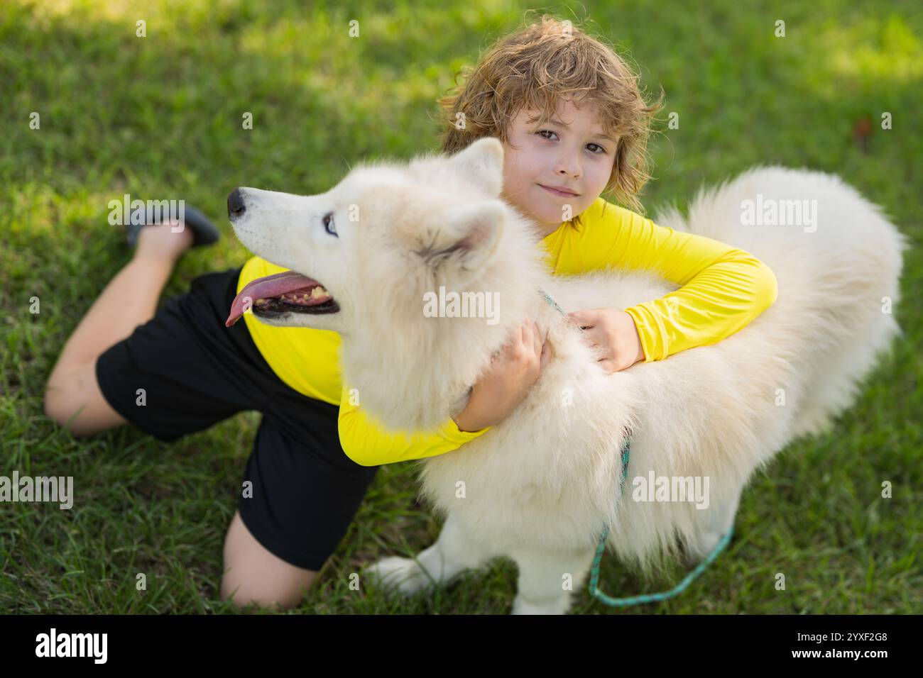 Child and dog outdoor portrait. Kids friend. Kid hugging dog in the ...