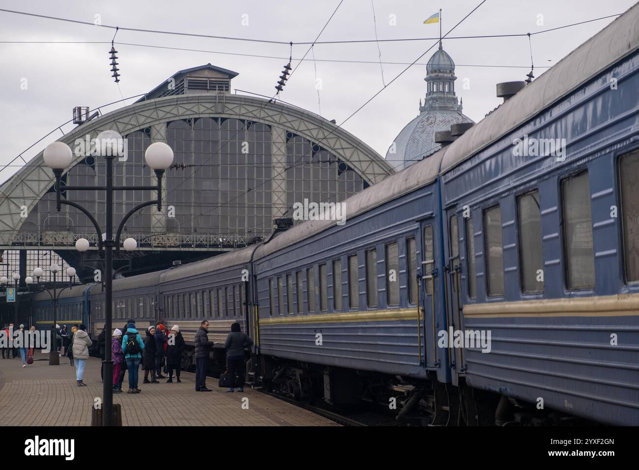 Train Station with Arched Roofs and Blue Train Stock Photo - Alamy