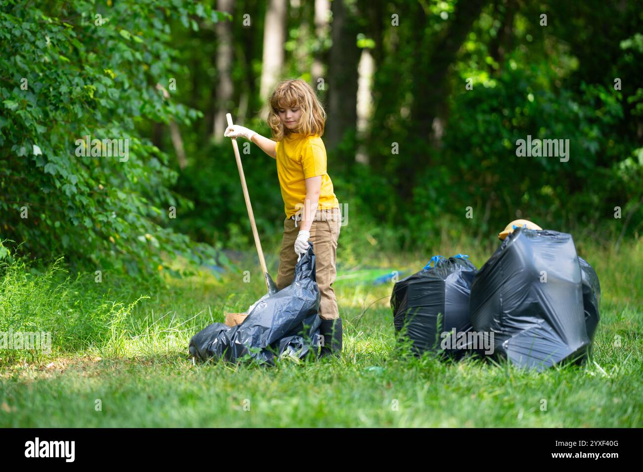 Global environmental pollution. Child collects plastic trash outdoor ...