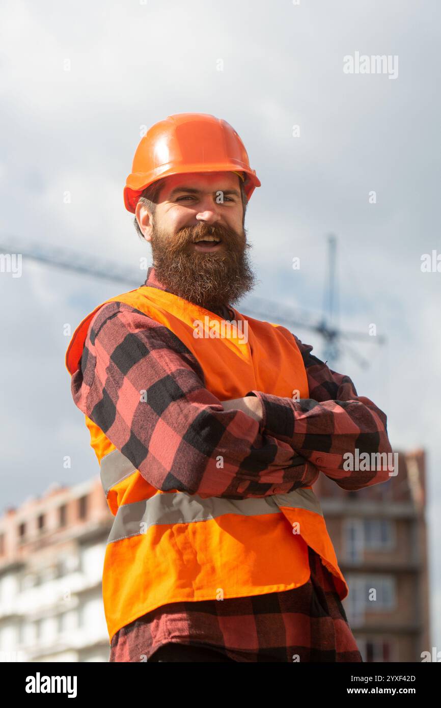Portrait of worker man at construction site. Improvement and renovation ...