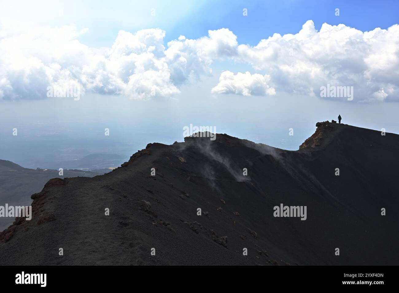 Volcanic Landscape on Mount Etna. Rocky volcanic terrain under a cloudy ...
